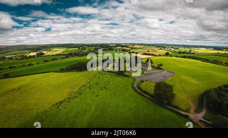 An aerial drone view of the Cappagh Parish Church in Northern Ireland ...