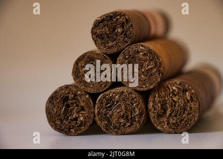 A pyramid stack of six Cuban cigars on the white background Stock Photo ...