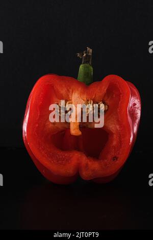 Angry face made from fresh natural vegetables flying above background ...