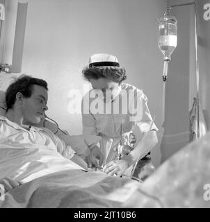 1950s NURSE PATIENT WOMAN BED HOSPITAL SICKNESS ILLNESS Stock Photo - Alamy