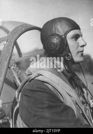 Pilot in the 1940s. A pilot in his plane with earphones visible in the ...
