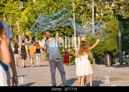 Street artist creates beautiful giant soap bubbles in Athens Stock ...