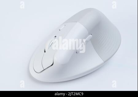 Ergonomic vertical mouse with laptop computer on adjustable desk at ...