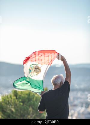 Senior man holding flag of Mexico. "September 16. Independence Day of ...