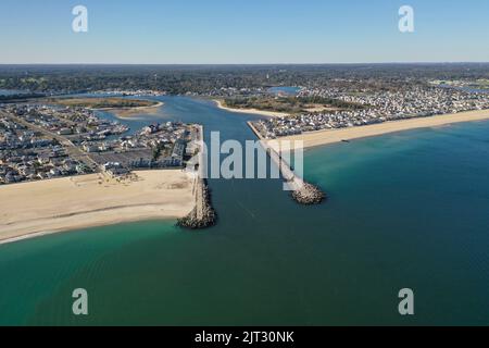 A drone shot of the Manasquan Inlet in New Jersey on a bright sunny day ...