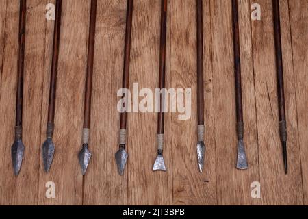 Different types of arrowheads made of iron on wooden background Stock ...