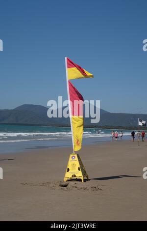 Australian lifeguard signs and red and yellow flags at Four Mile Beach ...