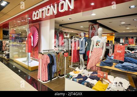 SINGAPORE - CIRCA JANUARY, 2020: clothes on display at Uniqlo store in Singapore Changi Airport ...