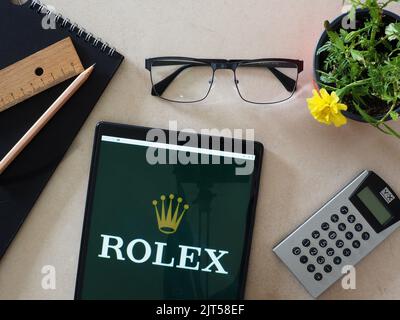 In this photo illustration, a Rolex SA logo seen displayed on a tablet ...