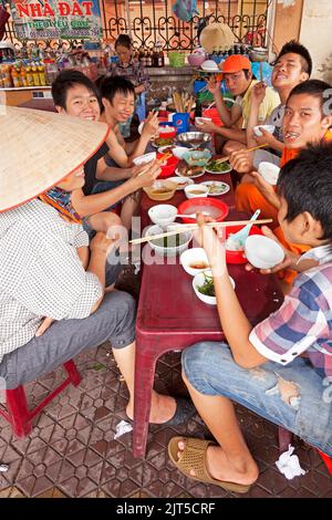 Vietnamese girls eating at open air street restaurant, Hai Phong ...