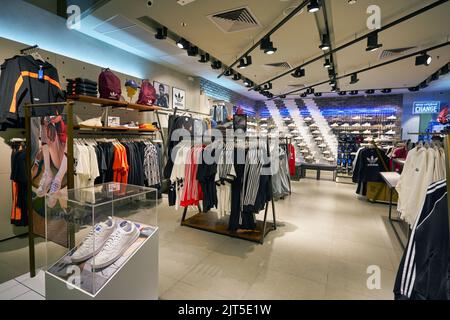 SINGAPORE - CIRCA JANUARY, 2020: clothes on display at Uniqlo store in Singapore Changi Airport ...