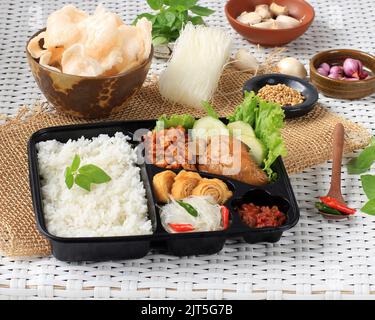 Rice Box or Indonesian lunch box with chicken meat, tofu, spicy potato ...