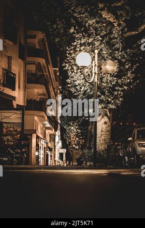 A vertical ground-level shot of a city at night Stock Photo - Alamy
