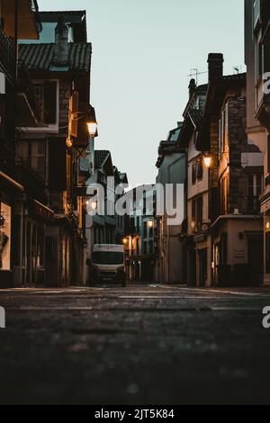 A vertical ground-level shot of a city at night Stock Photo - Alamy