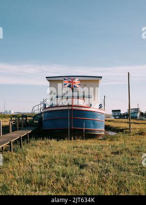 The summer houseboat and low tide salt marsh landscape of West Mersea ...