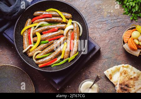 Arabic cuisine; Egyptian traditional sausage with onions, bell peppers ...