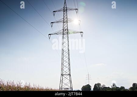 Electricity pylon in backlight Stock Photo - Alamy