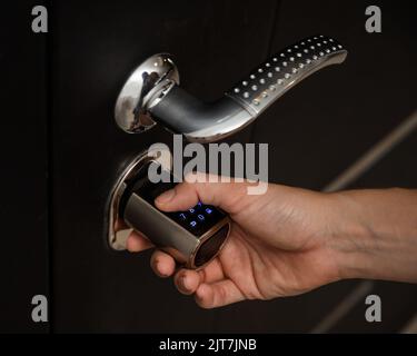 Woman opens the combination lock on the door to the apartment. Keyless ...