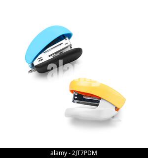 Two colorful staplers isolated on white background Stock Photo - Alamy