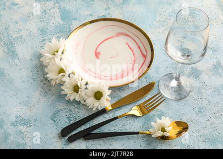 Stylish table setting with beautiful chamomile flowers on grunge ...