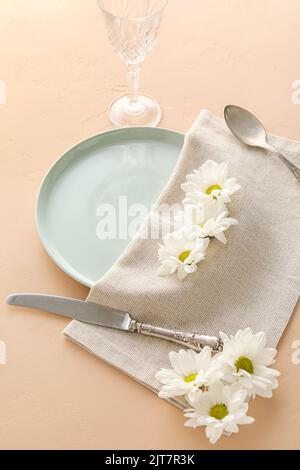 Simple table setting with chamomile flowers on beige background Stock ...