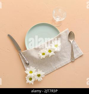Simple table setting with chamomile flowers on beige background Stock ...