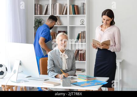 Different teachers working in school Stock Photo - Alamy