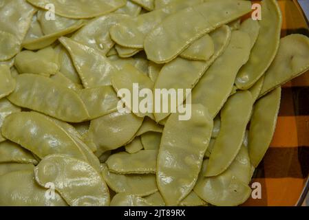Pod beans served on a platter for consumption. The pod or snap bean is ...