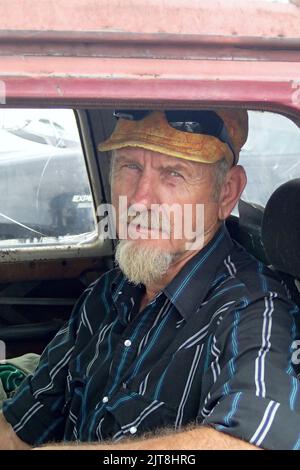 Aggressive man in striped t-shirt looking with loathing and showing ...