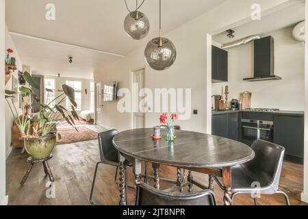 Couches and table located near TV against dining area of spacious room ...