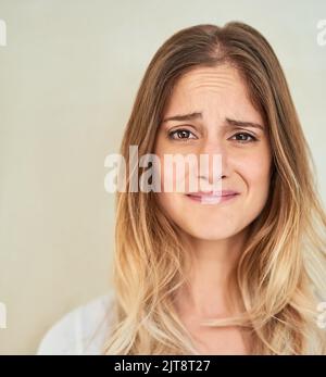 Are you sure about this. Portrait of a young woman making a face in ...