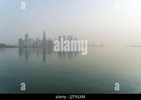 Doha skyline at sunrise with morning fog Stock Photo - Alamy