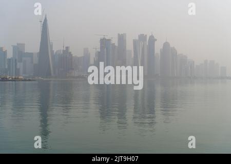 Doha skyline at sunrise with morning fog Stock Photo - Alamy