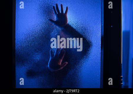 Shadow of woman screaming behind the glass, domestic violence concept ...