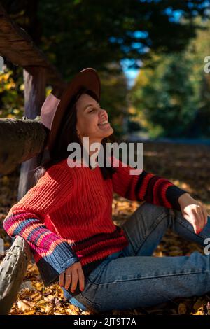 happy woman posing near fence autumn sunny day Stock Photo - Alamy