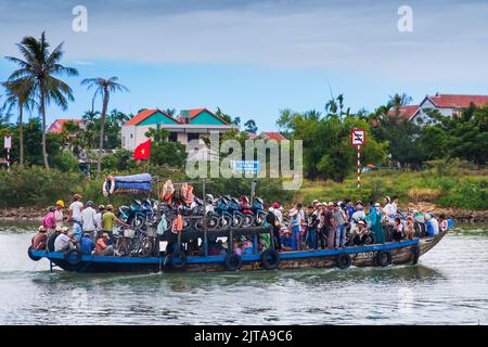 Vietnam, Hoi An Ferry boat bringing people and their mopeds to one of ...