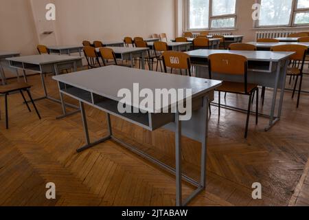 A fragment of the interior of the classroom with desks in an ...