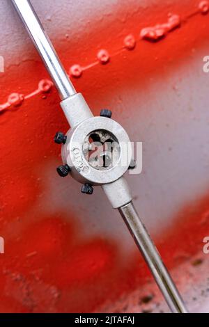 a die for threading on a shelf in the workshop Stock Photo - Alamy