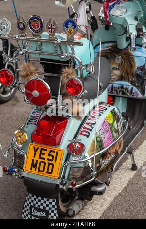 The back of a mod scooter with lots of lights and badges Stock Photo ...