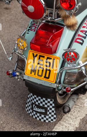 The back of a mod scooter with lots of lights and badges Stock Photo ...