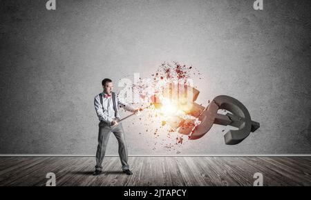 Determined banker man in empty concrete room breaking dollar figure ...