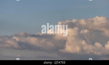 Puff Clouds in the Sky during sunset. Zoom in Stock Photo - Alamy