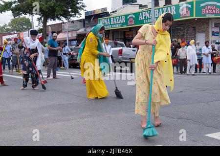 Devout Sikh men & women sweep Liberty Avenue where a parade float carry ...