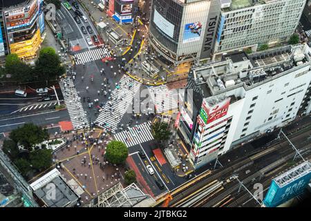 Pedestrians with umbrellas cross the multi-directional scramble ...
