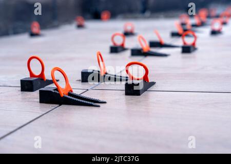close-up of the tile alignment system holding tile in given position ...