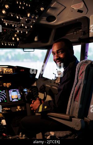 African american copilot using airplane command to fly plane ...