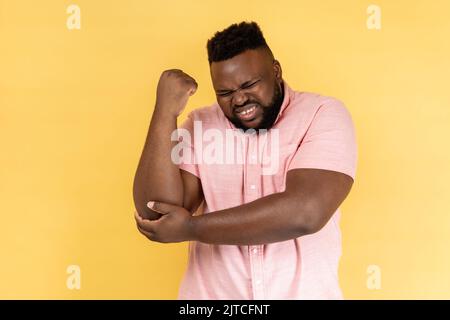 A man elbow bone ache, People suffering from pain in cubit on a gray ...