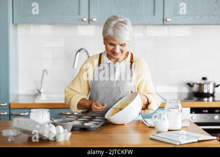 Old baking molds on an old kitchen table. Baking accessories in the ...