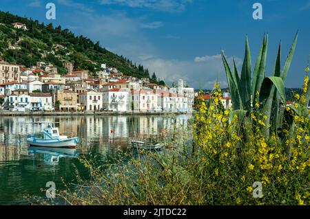 Pastel colored buildings on the waterfront and colorful fishing boats ...