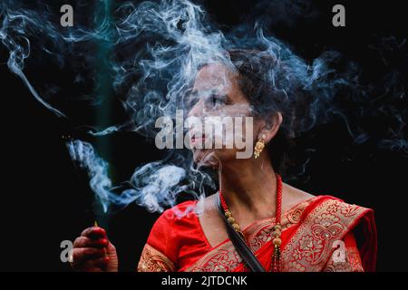 Bhaktapur, Bagmati, Nepal. 30th Aug, 2022. A Hindu woman handles her ...